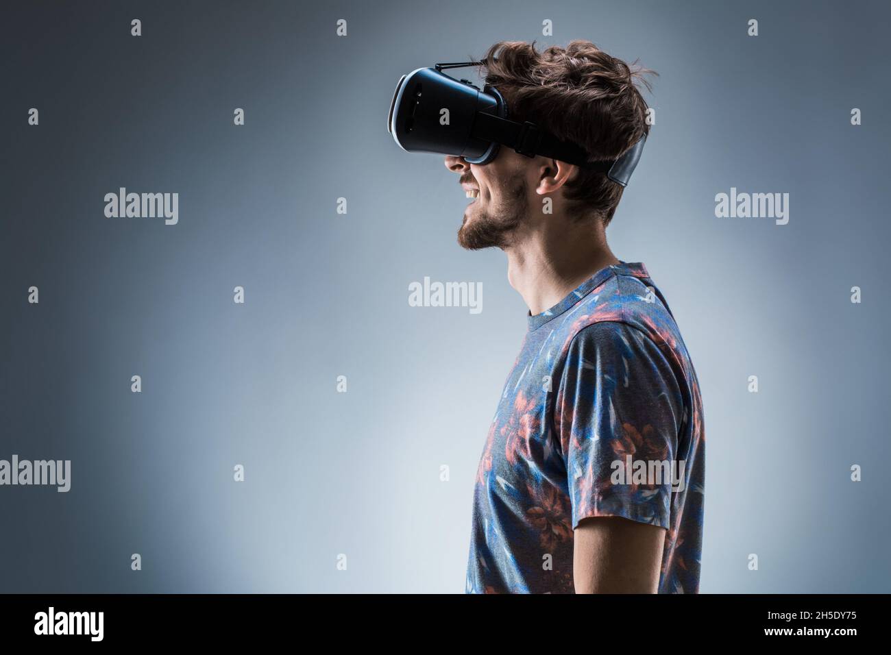 Side view of a young guy using a VR headset. Emotions Stock Photo - Alamy