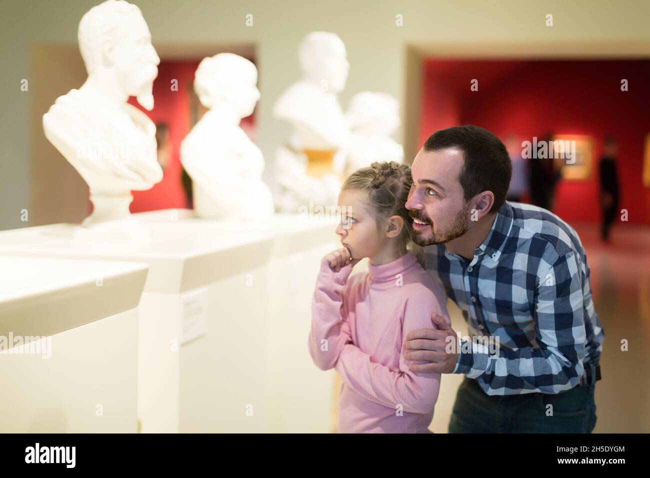 Positive father and daughter exploring statues Stock Photo - Alamy