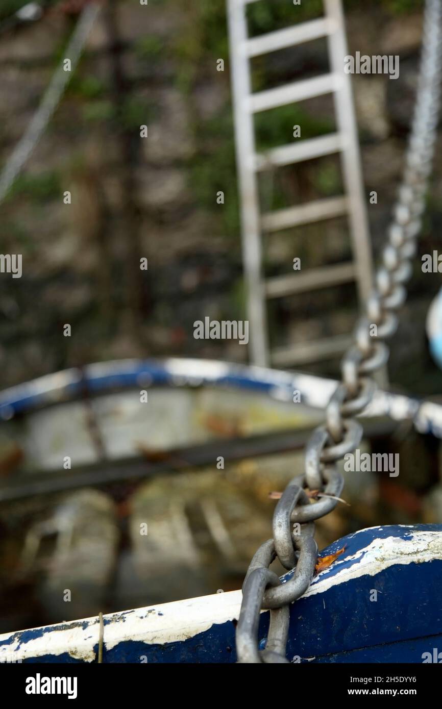 Steel chain securing small boat to sea wall Stock Photo - Alamy