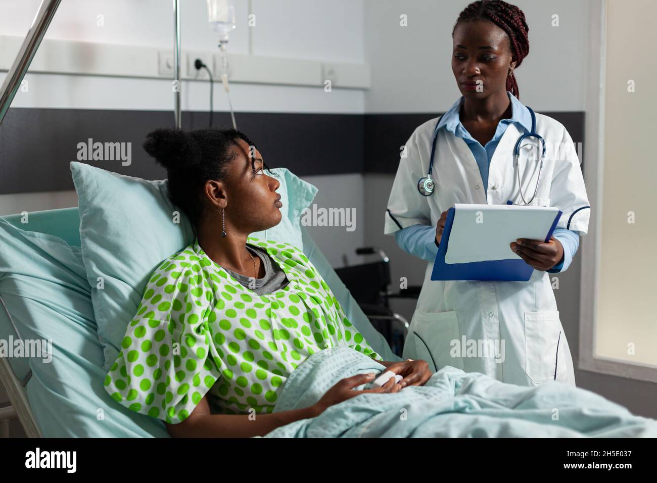 Sick woman patient lying in bed recovering after medical surgery while ...