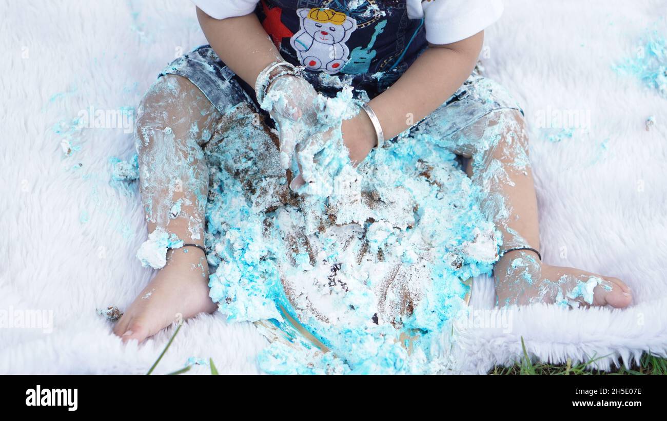curious baby boy poking finger in his first birthday cake Stock Photo ...
