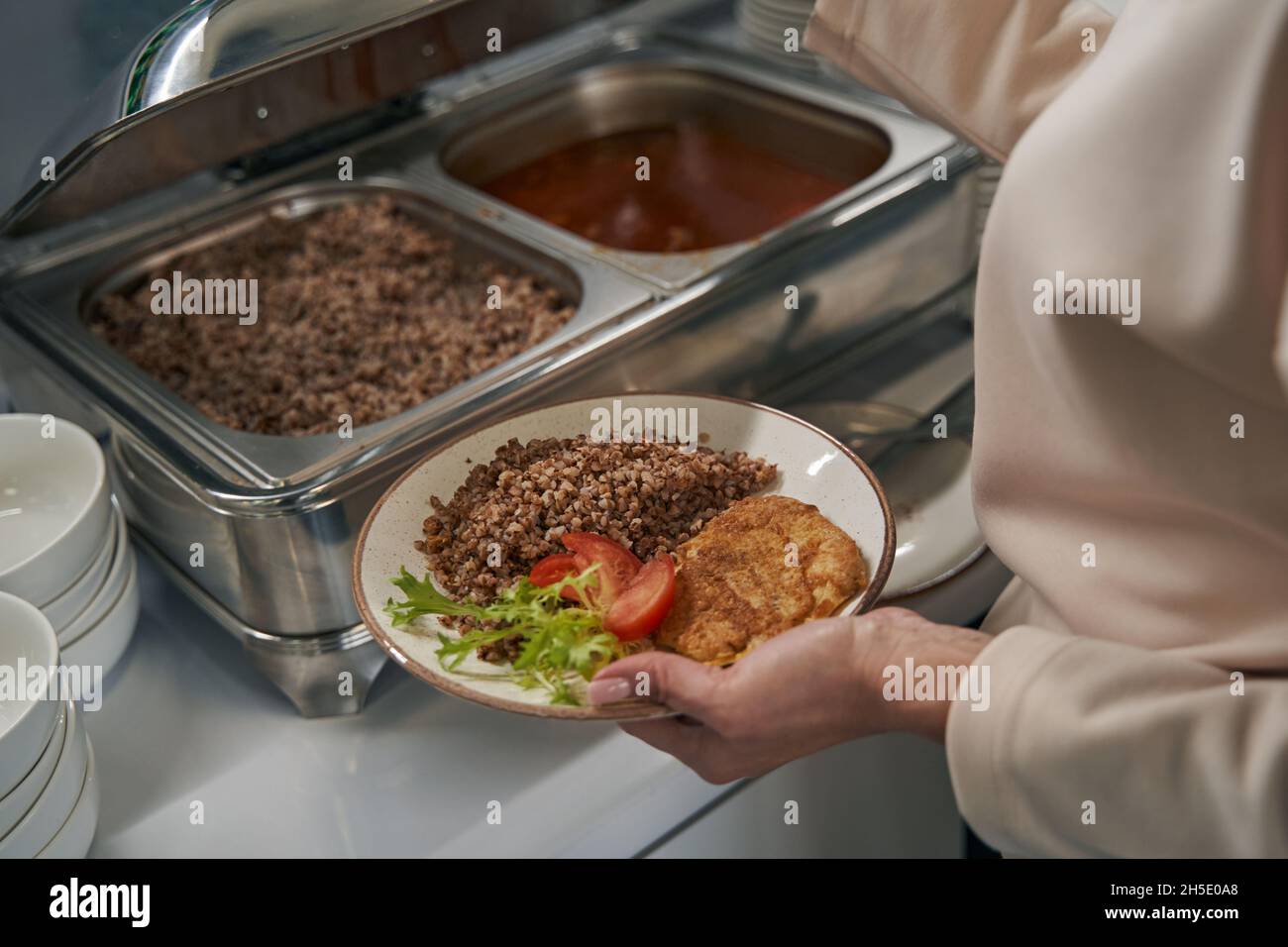 Female customer selecting food items in self-service restaurant Stock ...