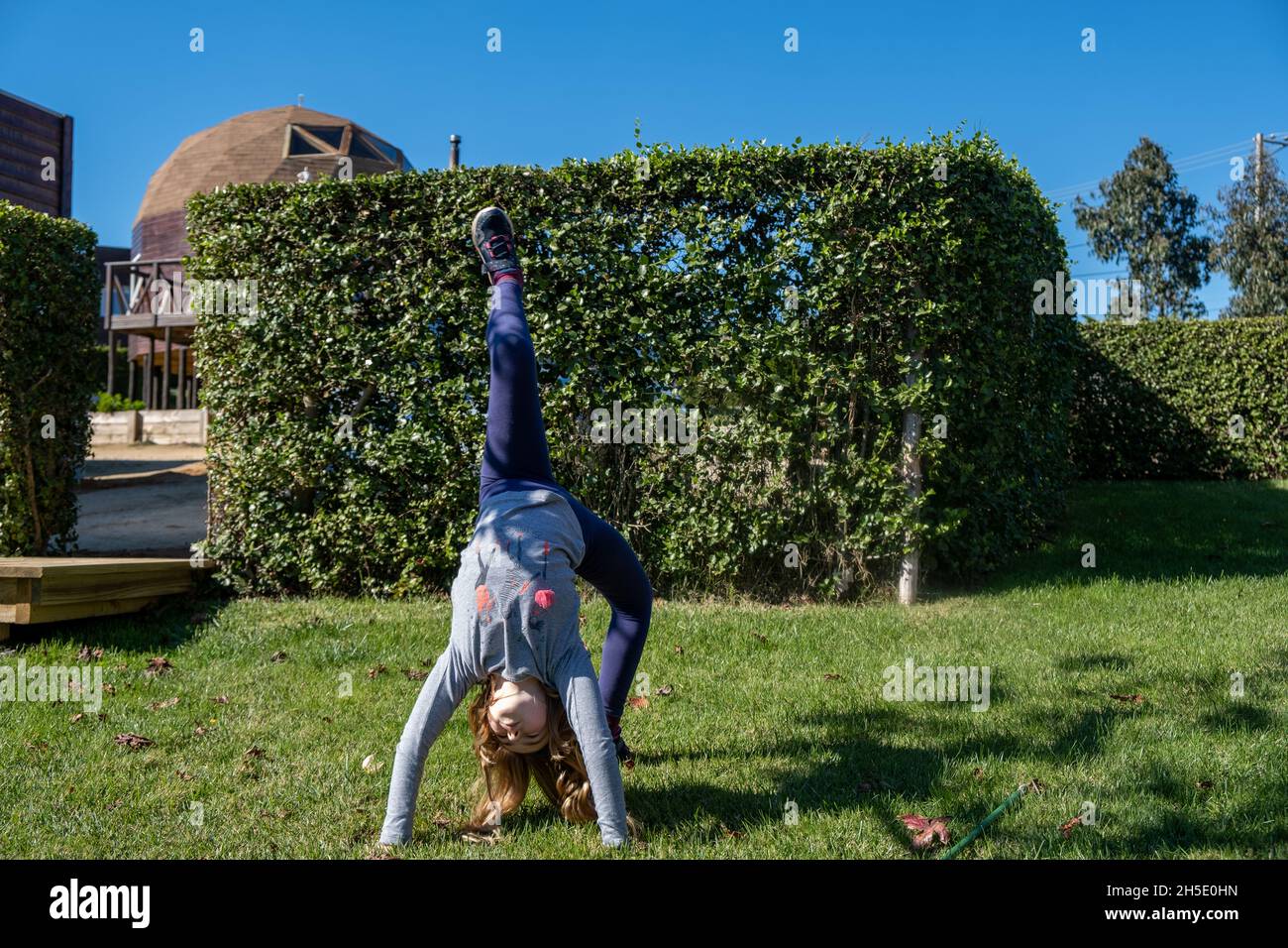happy girl playing in the park doing cartwheels Stock Photo - Alamy