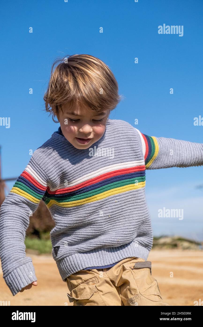 vertical photo of child playing in the garden Stock Photo - Alamy