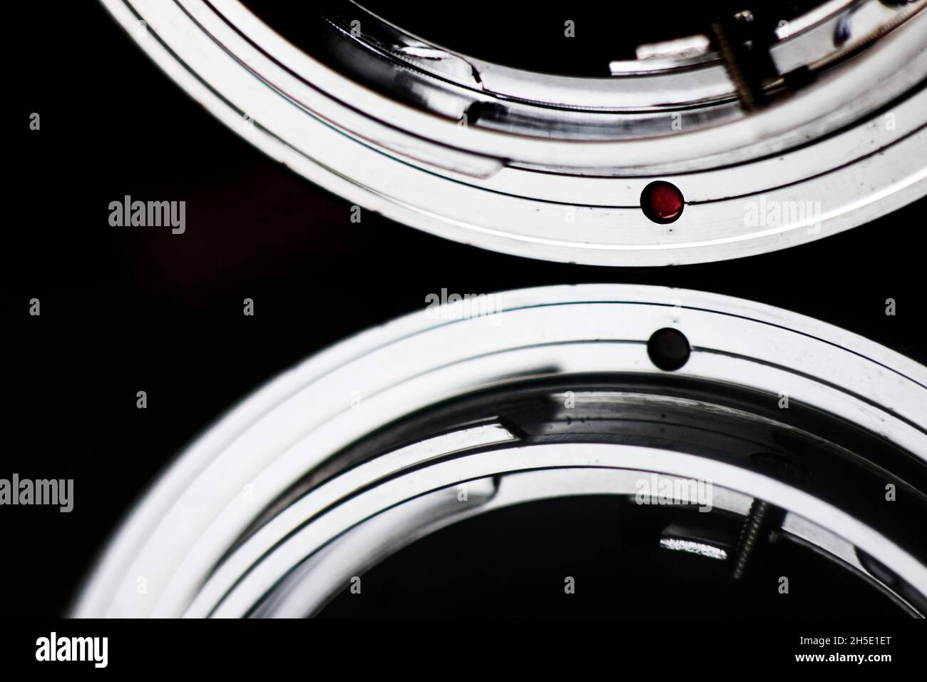 Macro shot of the red dot of a metal vintage camera lens adapter to ...