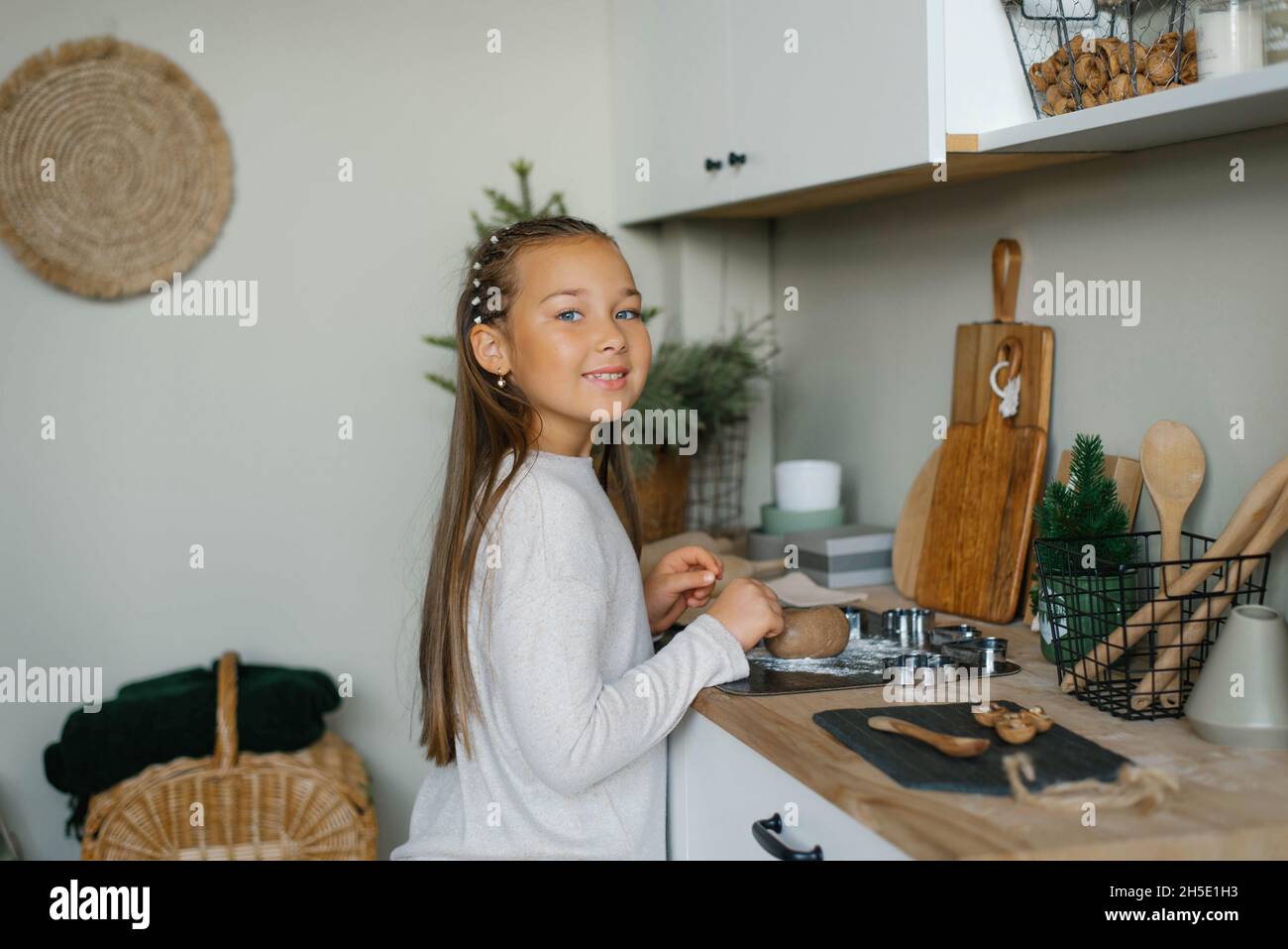 Six-year-old girl cooks ginger Christmas cookies in the kitchen Stock ...