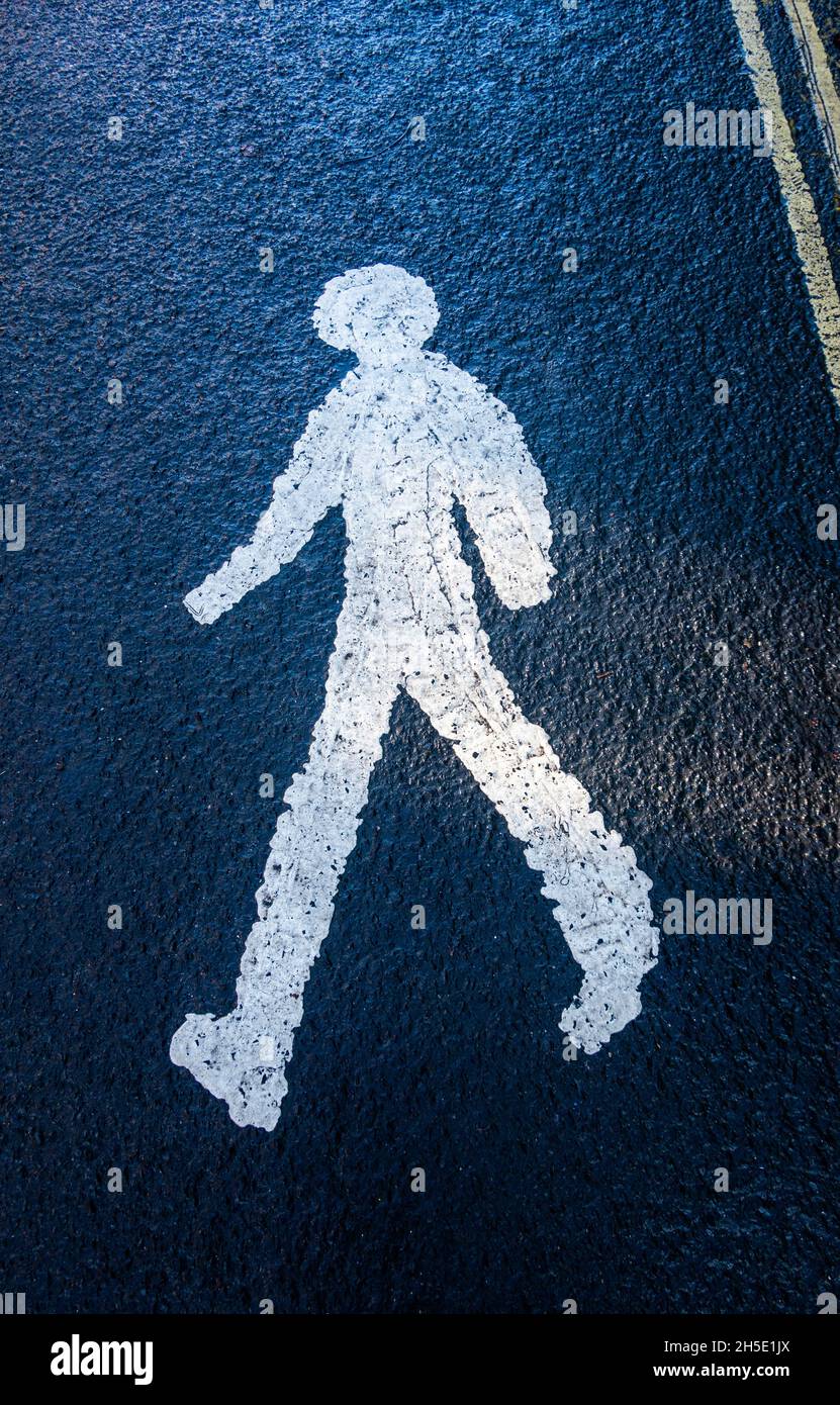 Illustration of a man walking painted on a road in Merseyside showing ...