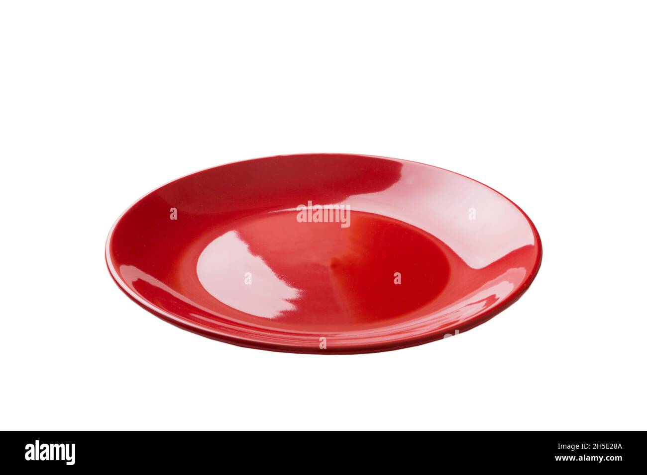 Red ceramic round plate isolated over white background. perspective ...