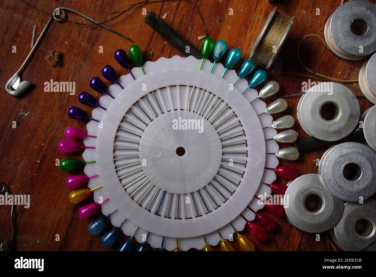A set of colorful needles and threads for sewing on the table Stock ...