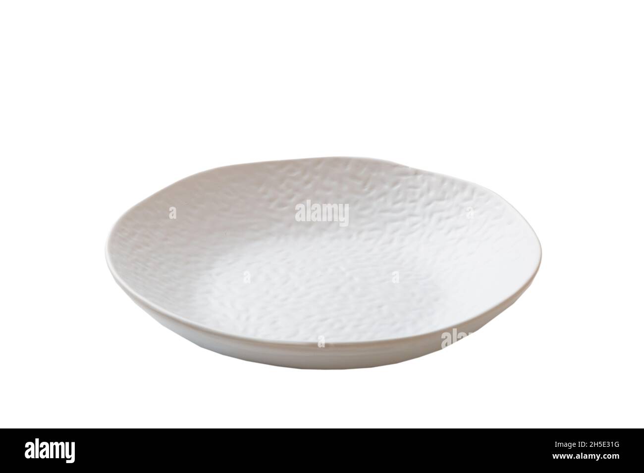White ceramic round plate isolated over white background. perspective ...