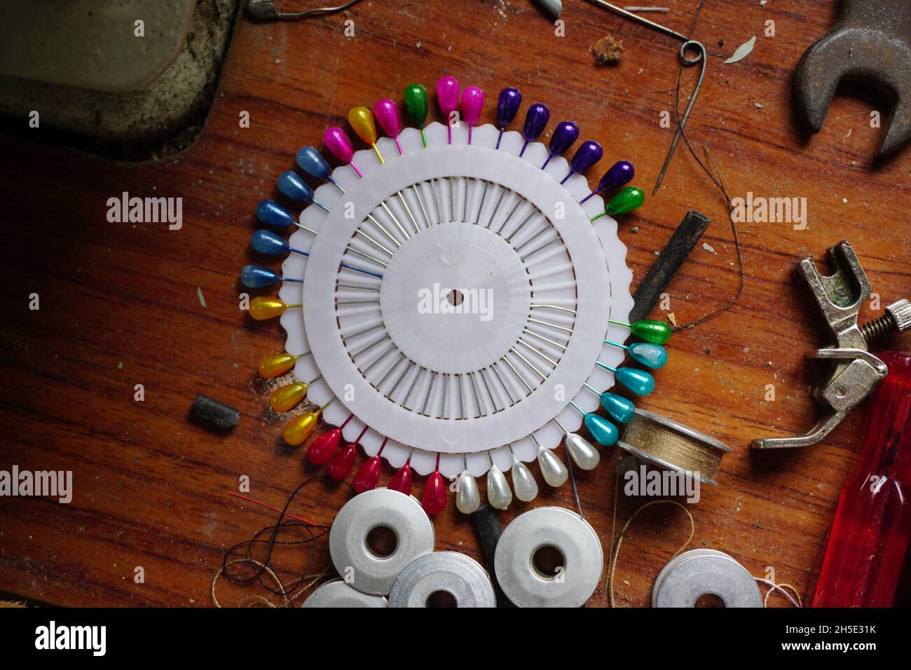 A set of colorful needles and threads for sewing on the table Stock ...
