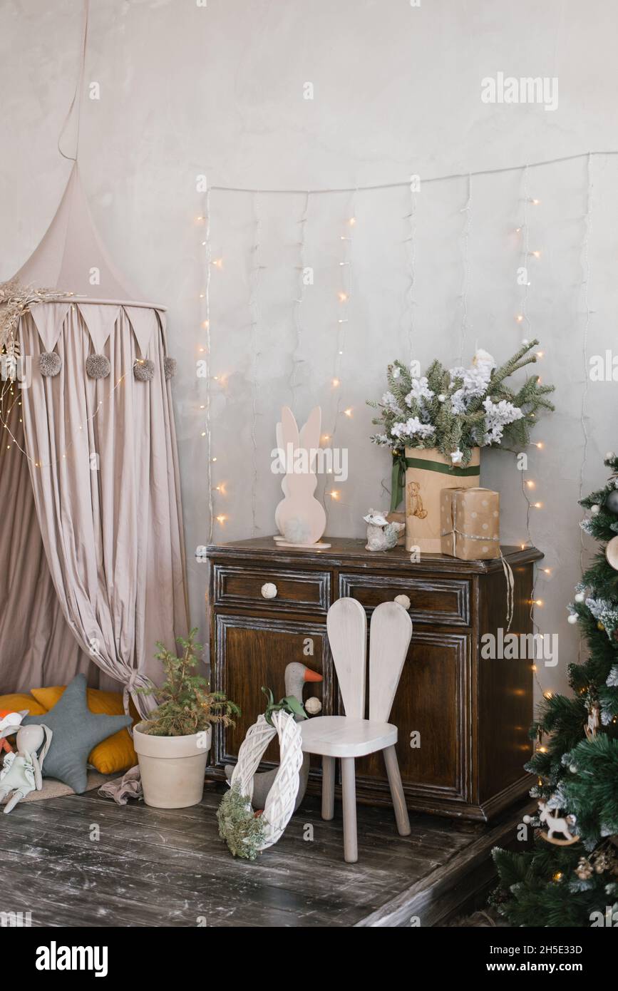 Interior of a children's room decorated for Christmas. Awning bed with ...