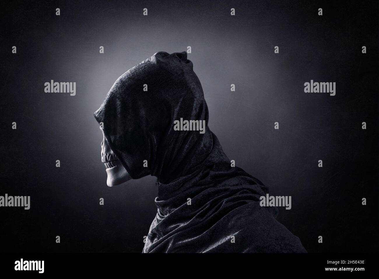 Grim reaper over dark misty background Stock Photo - Alamy