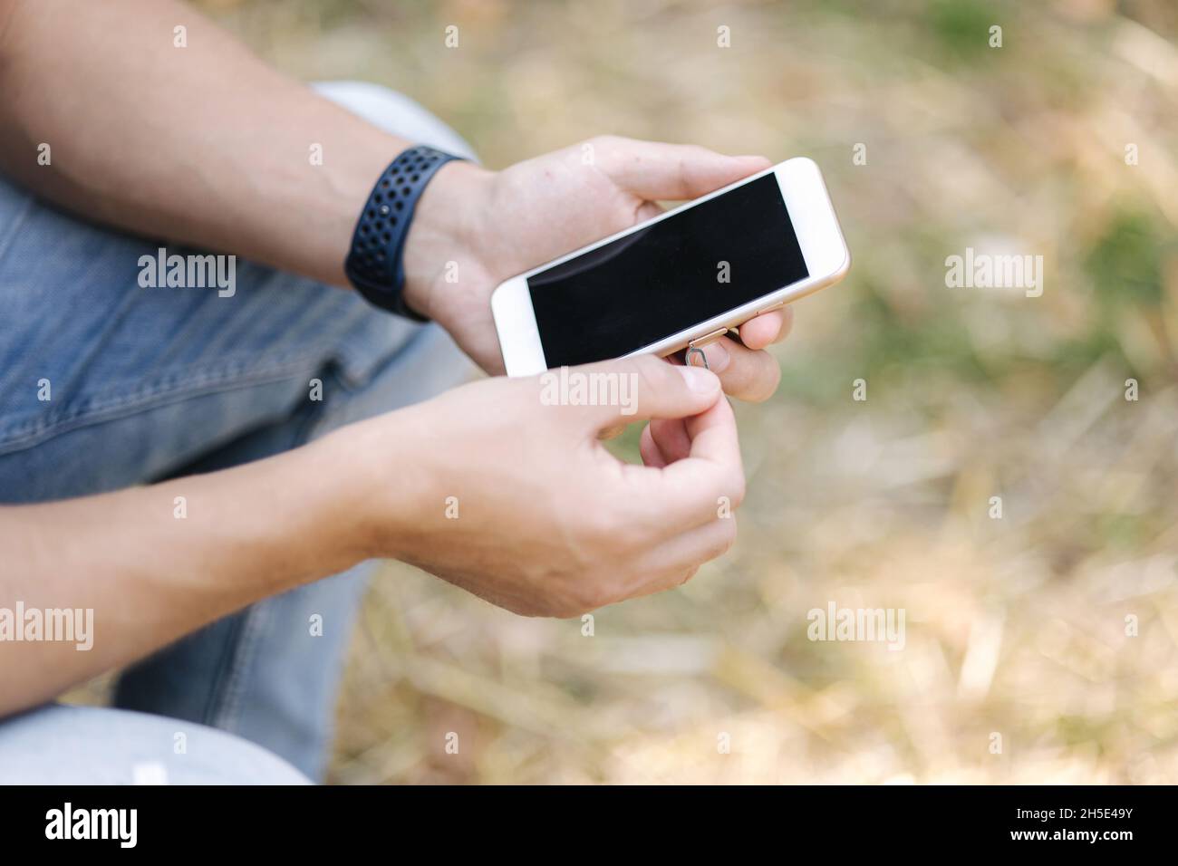 Man take SIM card from his phone. Close-up of man hold cellphone in ...
