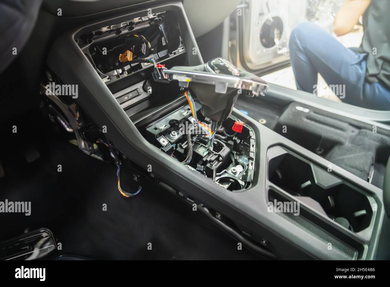 Dismantling car interior. Disassembled multimedia panel and gear lever ...