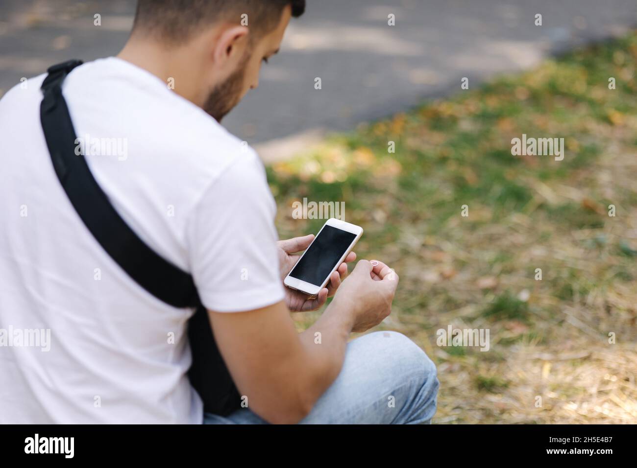 Man take SIM card from his phone. Back view of man sets his cellphone ...
