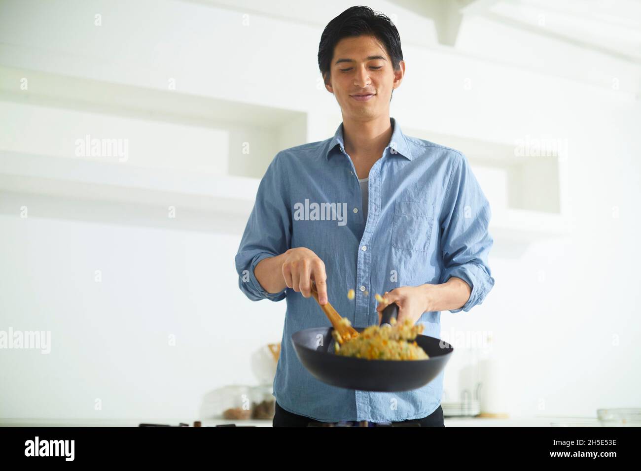 Japanese man cooking in the kitchen Stock Photo - Alamy