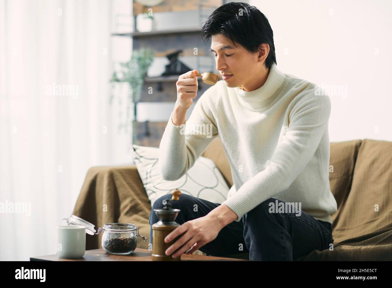 Japanese man relaxing on the sofa Stock Photo - Alamy