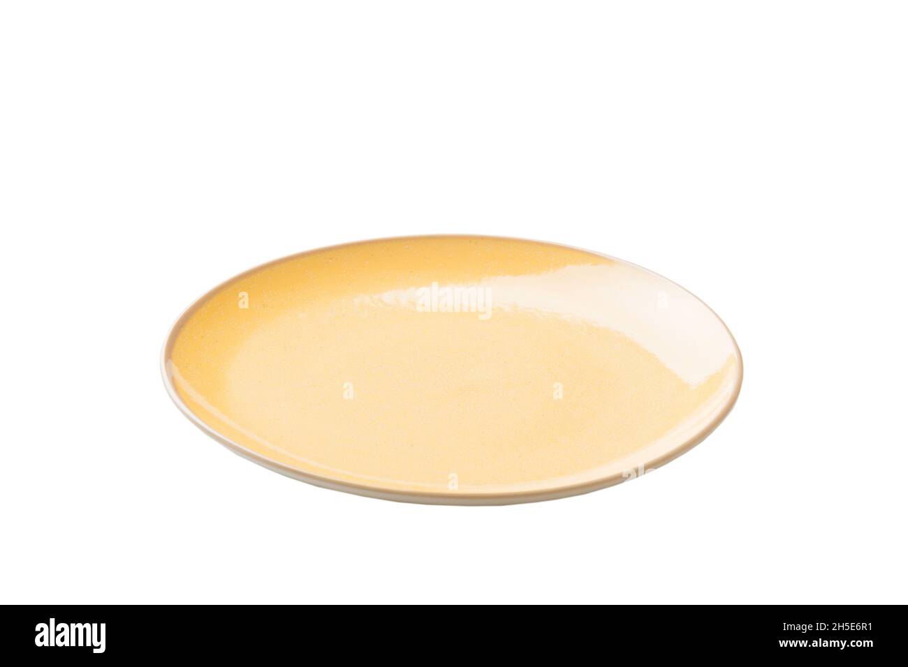 Yellow ceramic round plate isolated over white background. perspective ...