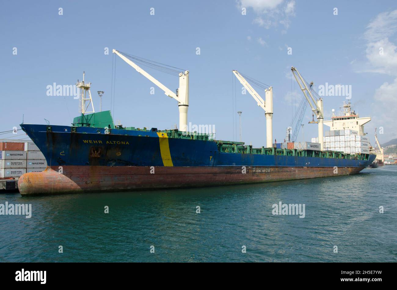 Moored container ship in a harbor waiting to be loaded in a harbor ...