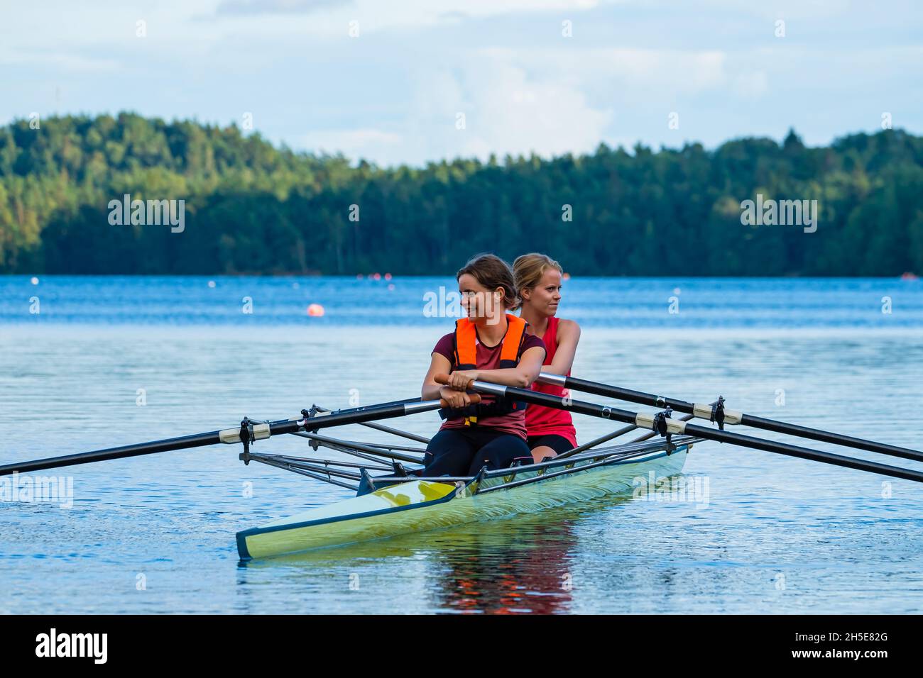Pair of Womans rowing on lake Stock Photo - Alamy