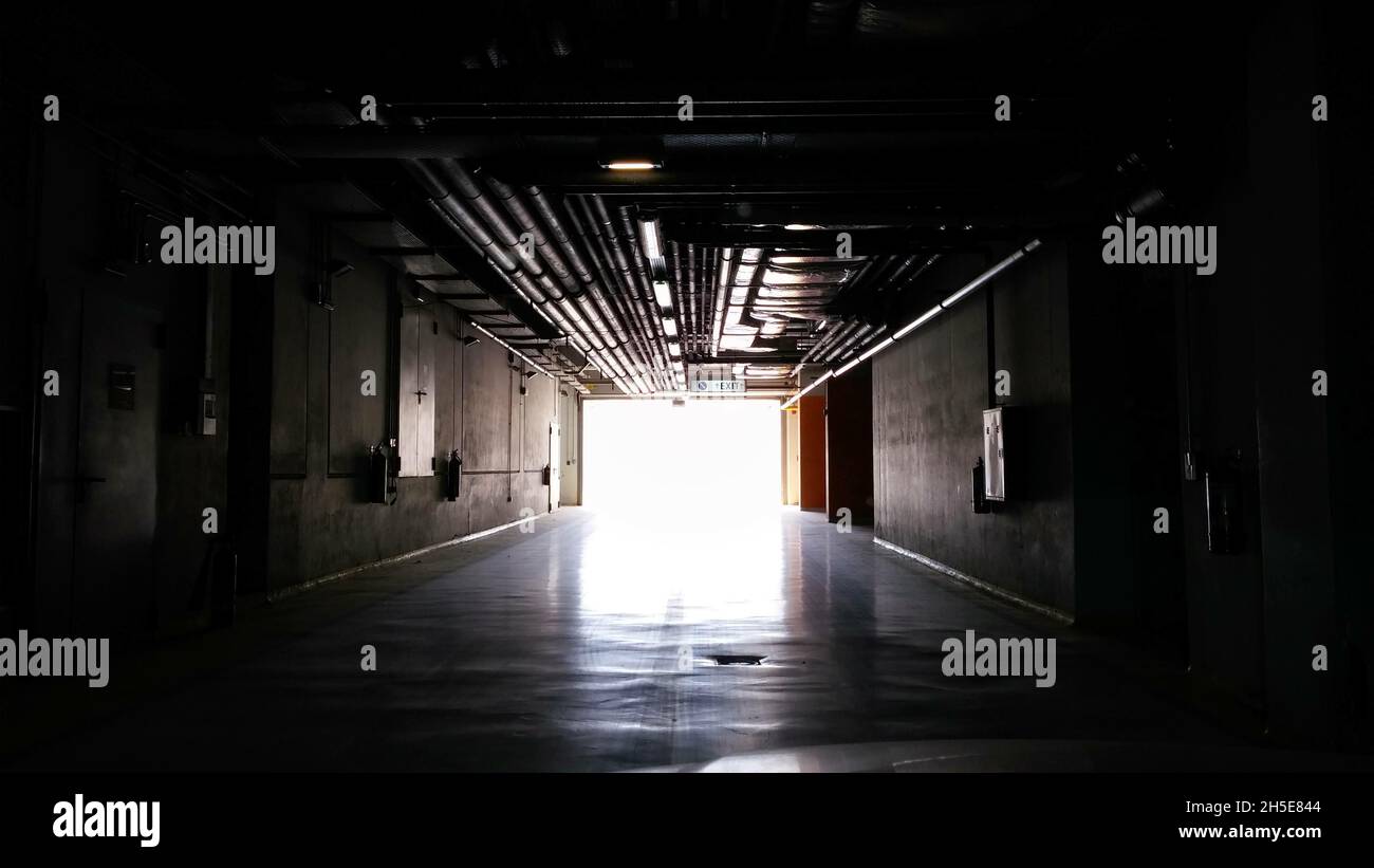 Hopeful light at the end of a dark underground Stock Photo - Alamy