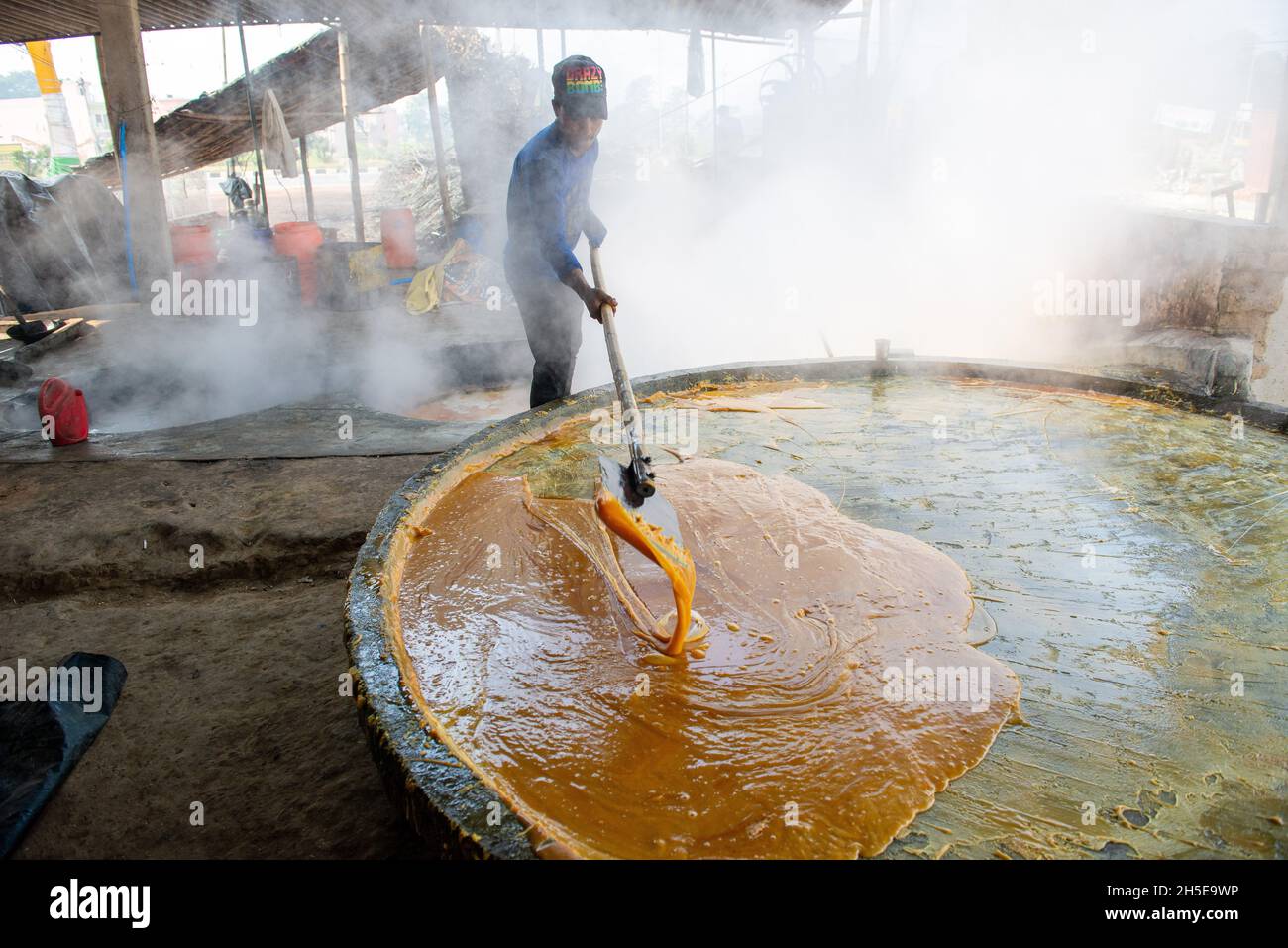 Roorkee, uttarakhand, India- Nov 7 2021: A worker stirs hot and thick ...
