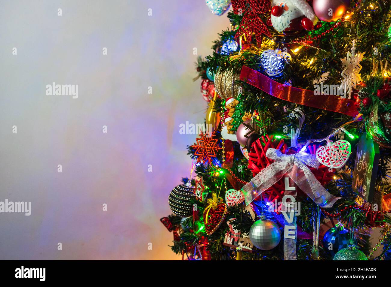 Beautifully decorated Christmas tree with illuminated colorful lights ...