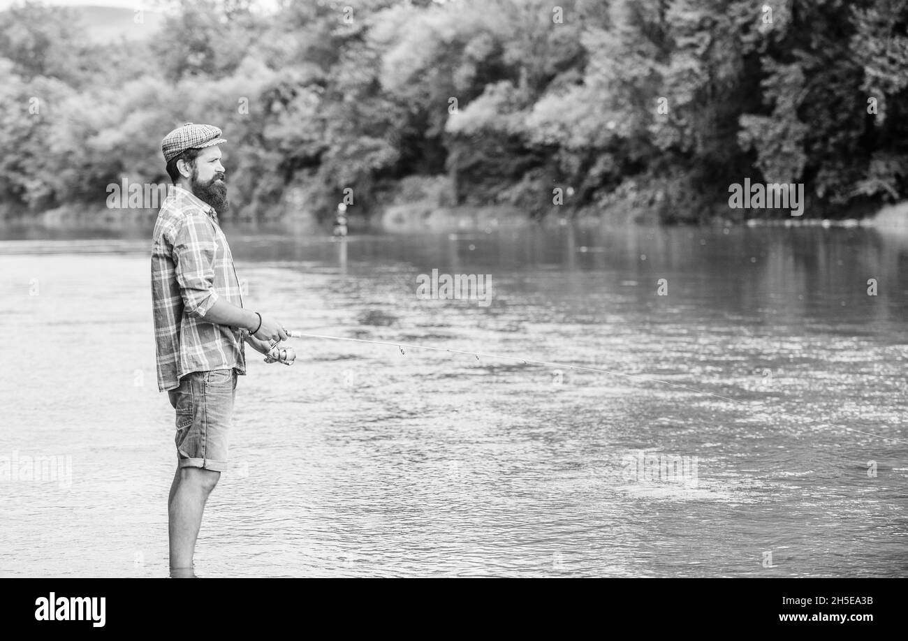 Fun of fishing is catching. Fisher with fishing equipment. Fish on hook ...