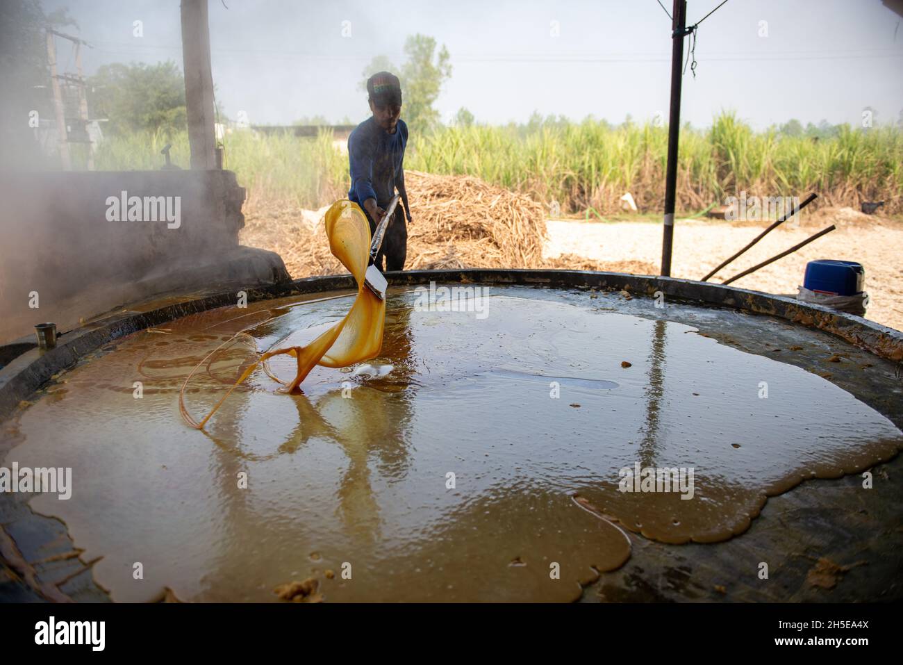 Roorkee, uttarakhand, India- Nov 7 2021: A worker stirs hot and thick ...