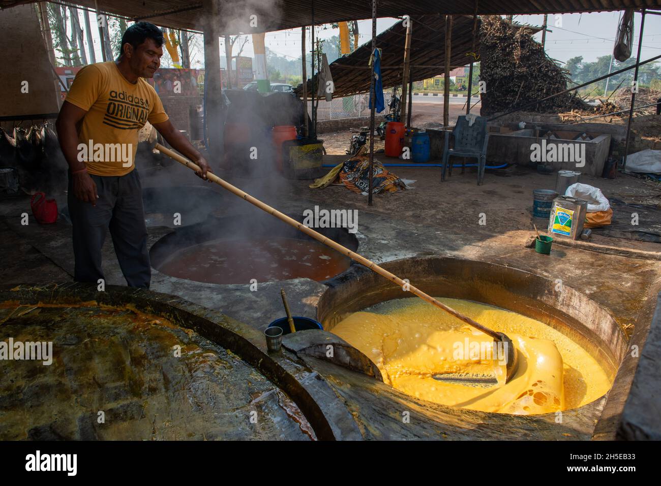Roorkee, uttarakhand, India- Nov 7 2021: A worker stirs hot and thick ...