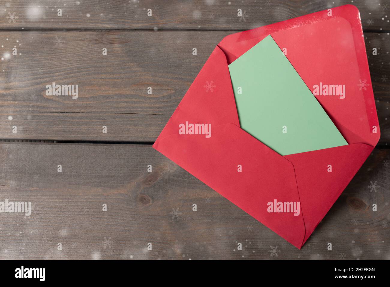 Wooden snowy background with red letter Stock Photo - Alamy