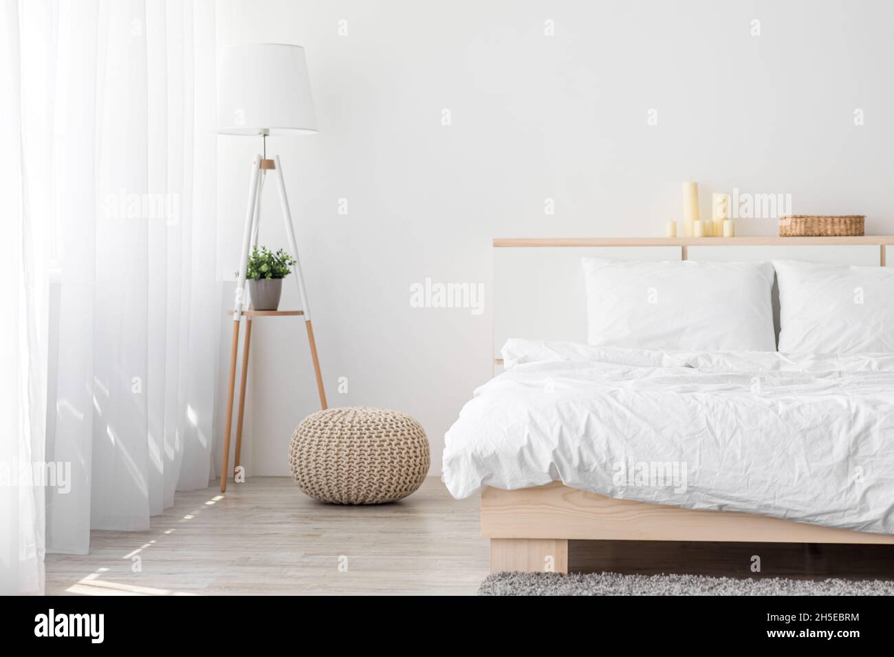 Big double bed with comfortable bedding, lamp in bedroom, gray carpet ...