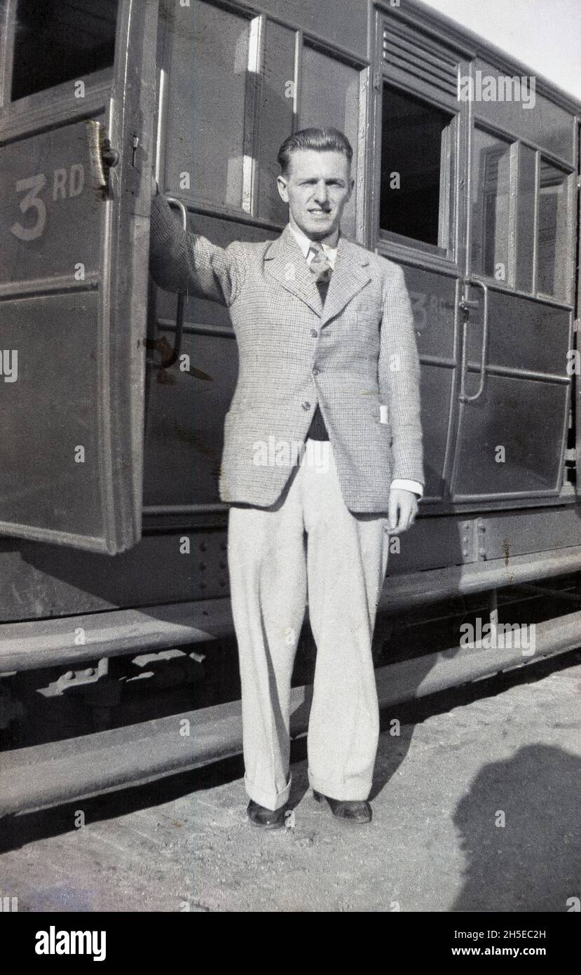 1940s, historical, a man standing on a railway platform holding the ...