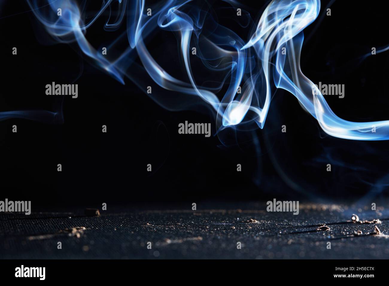 smoke above ashes on black background with abstract blur motion wave ...