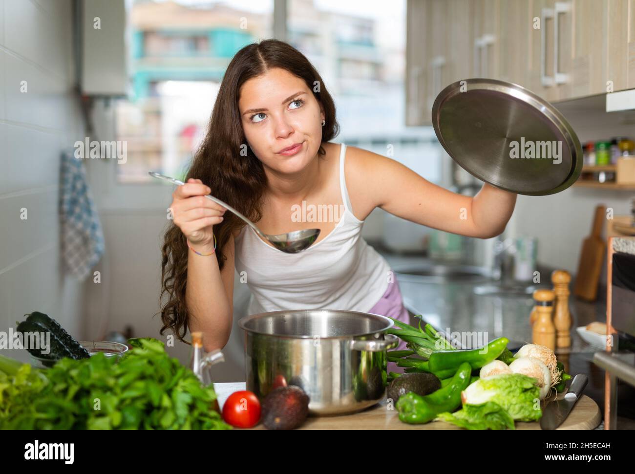 Woman cooking vegetables confused hi-res stock photography and images ...