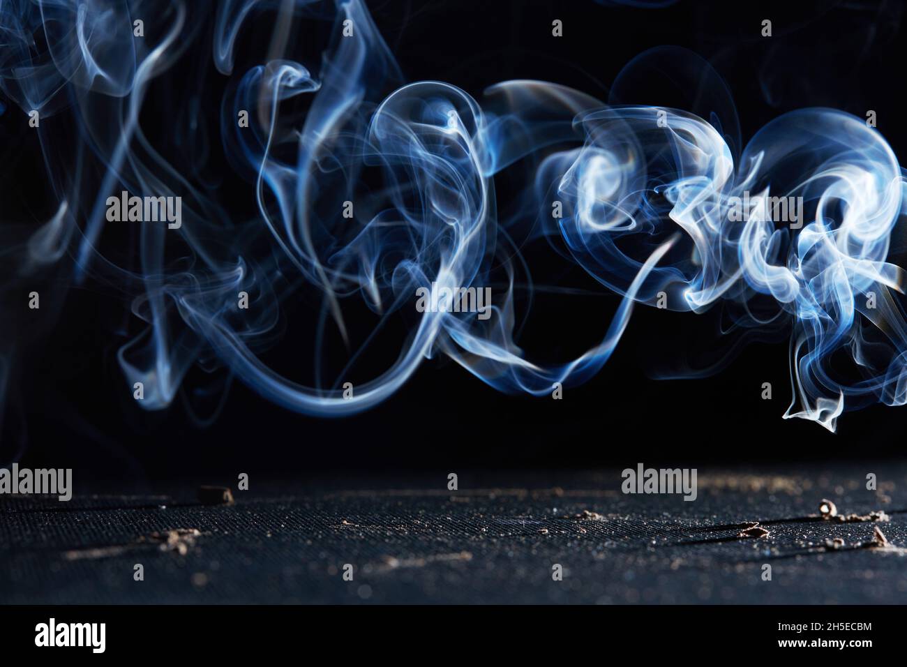 smoke above ashes on black background with abstract blur motion wave ...