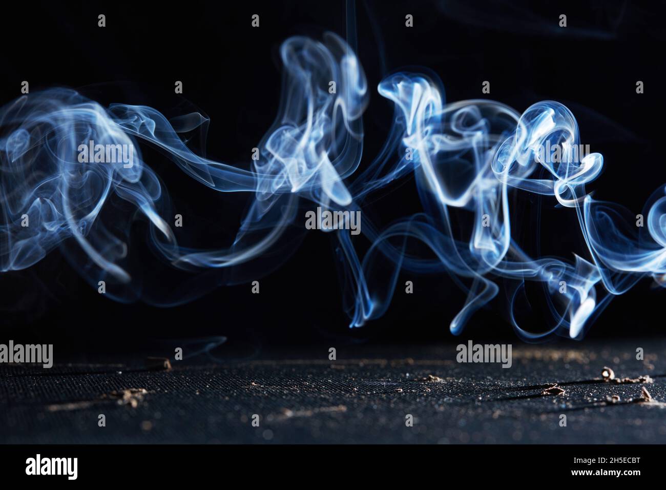 smoke above ashes on black background with abstract blur motion wave ...