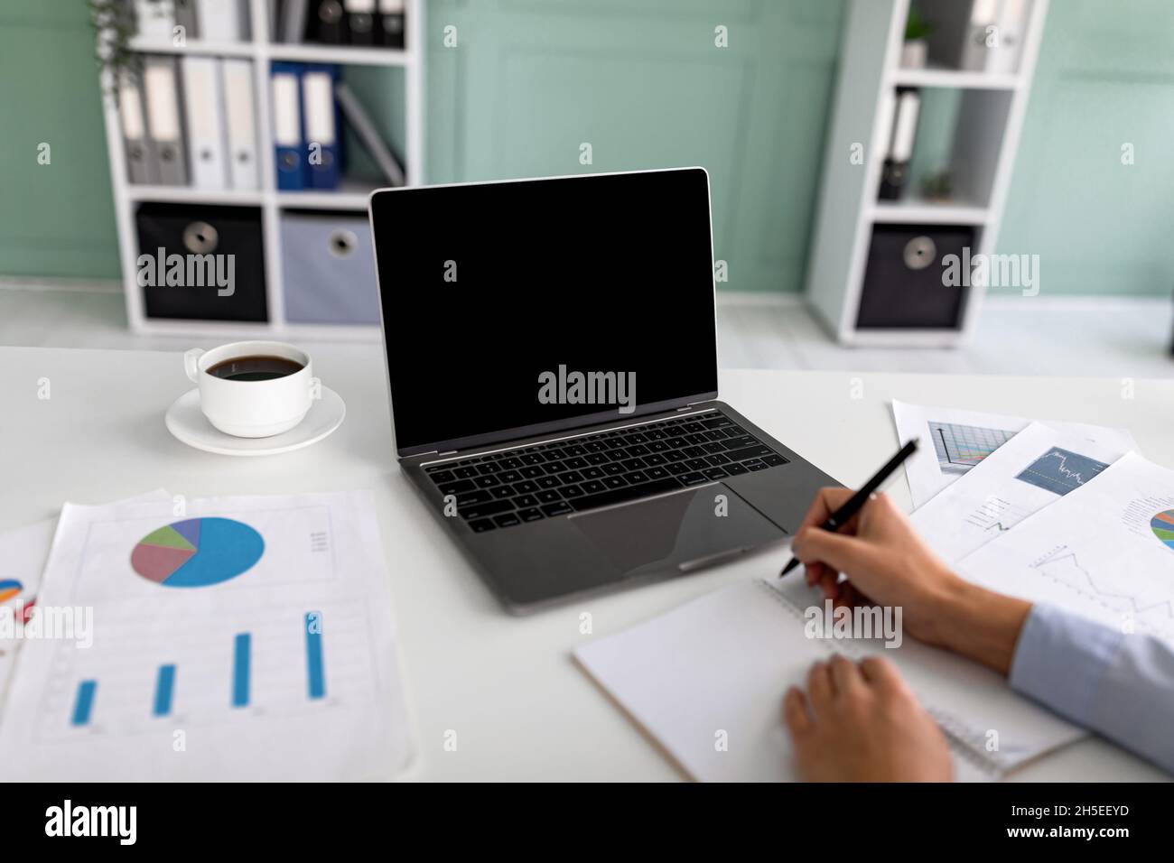 Lady ceo or financial manager having online conference and taking notes ...