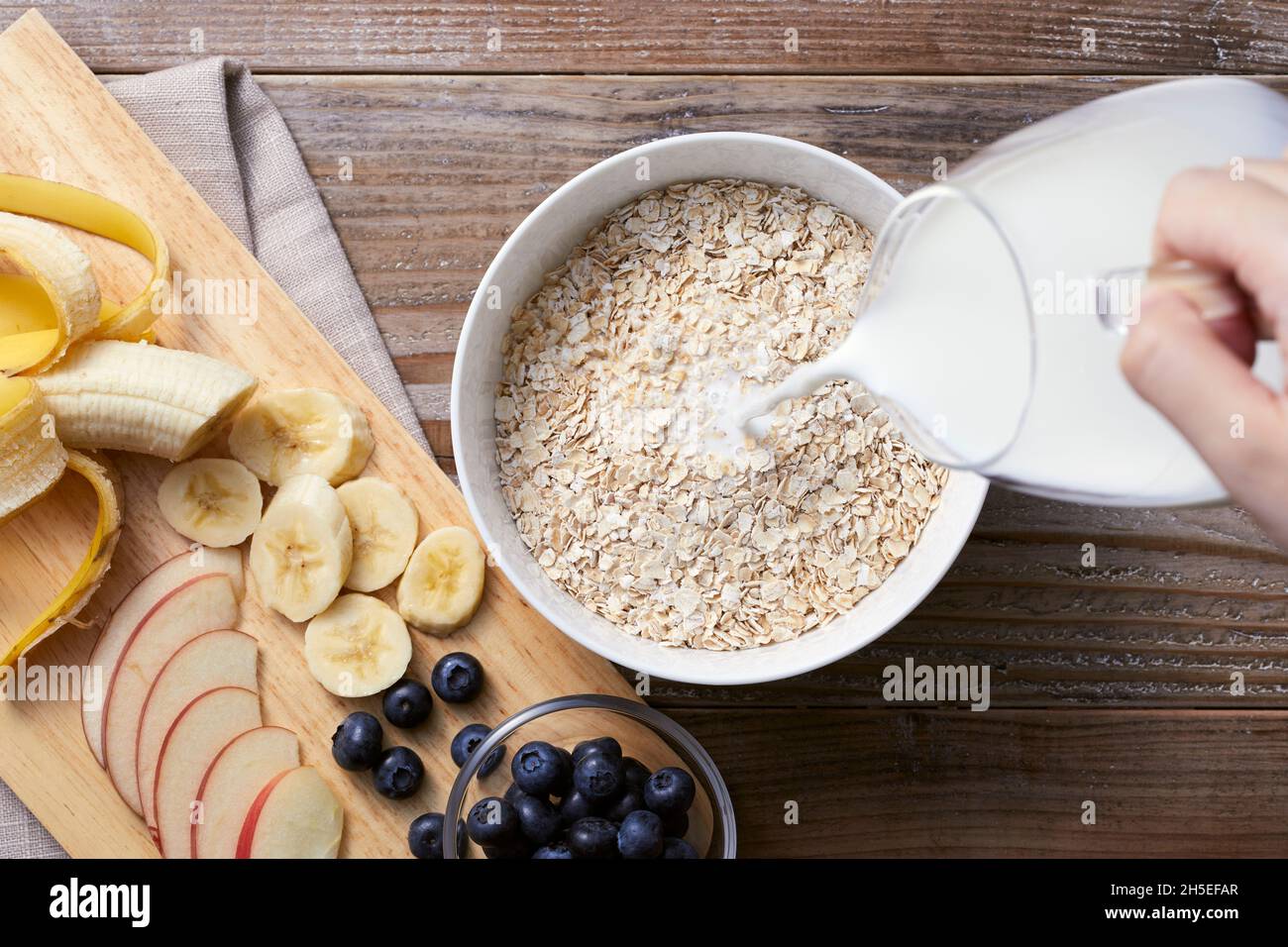 Person pouring oatmeal hi-res stock photography and images - Alamy