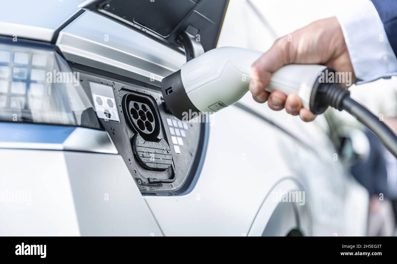 Male hand inserts power connector hi-res stock photography and images ...