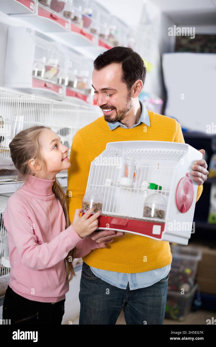 Father and daughter boasting their purchase of bird Stock Photo - Alamy