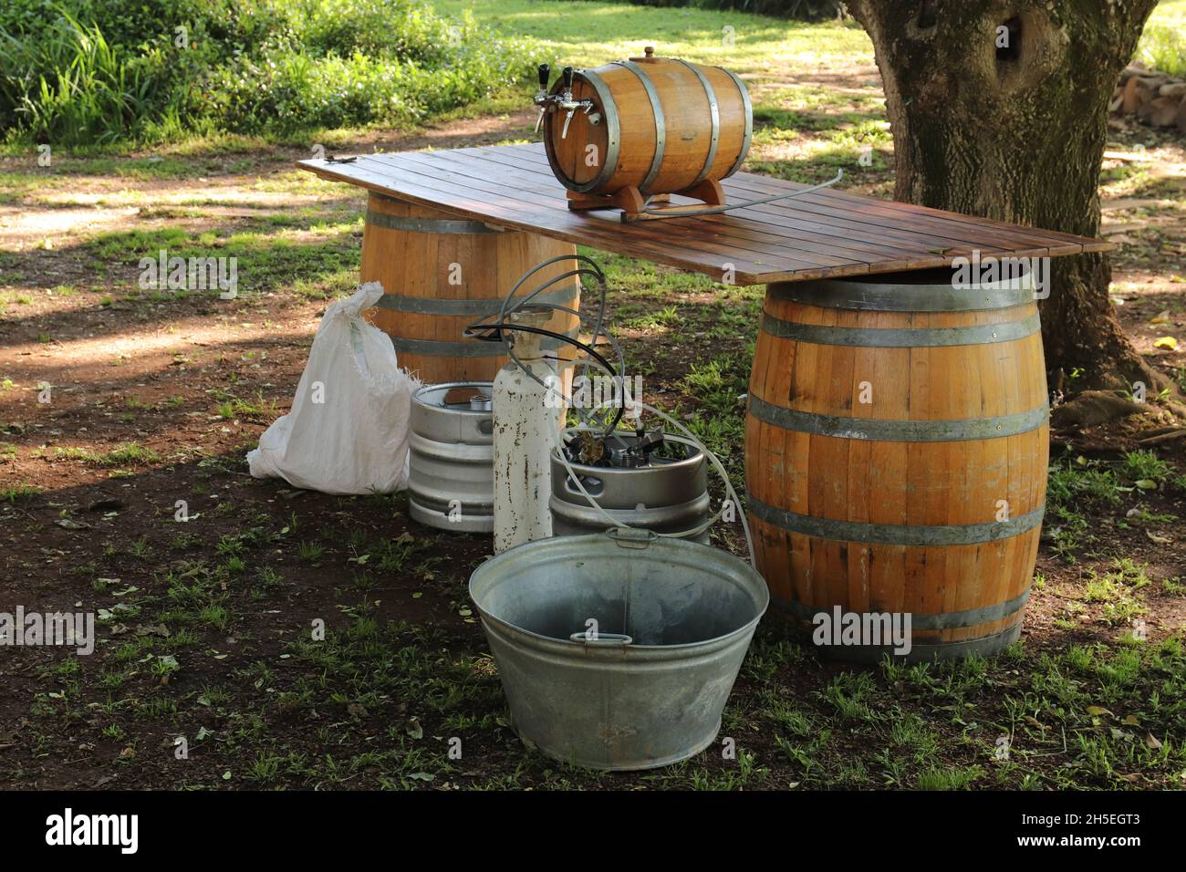 Barrel with cranes on a self-made wooden table and several metal ...