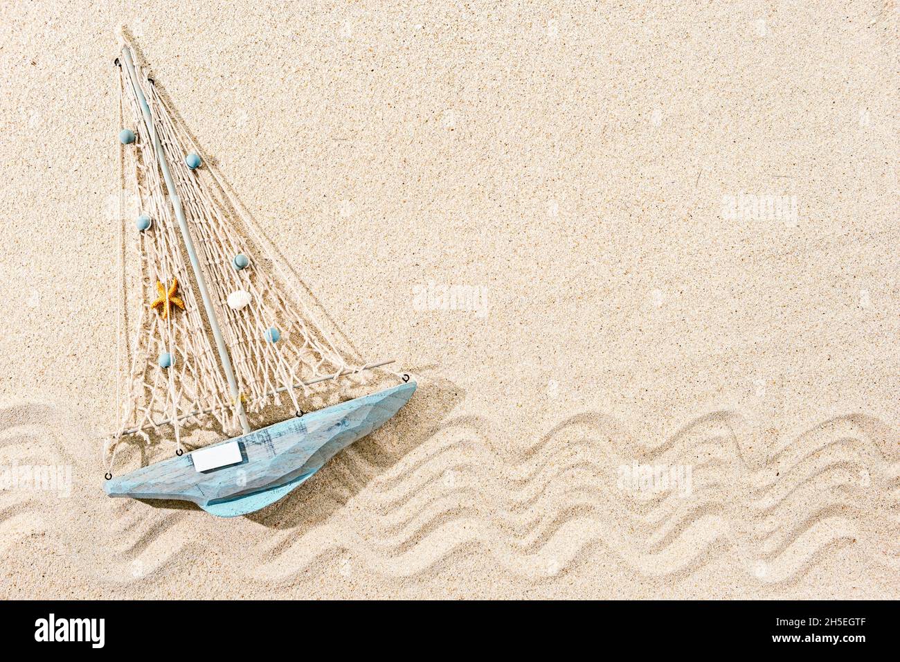 Wooden toy ship on sand, top view, copy space Stock Photo - Alamy