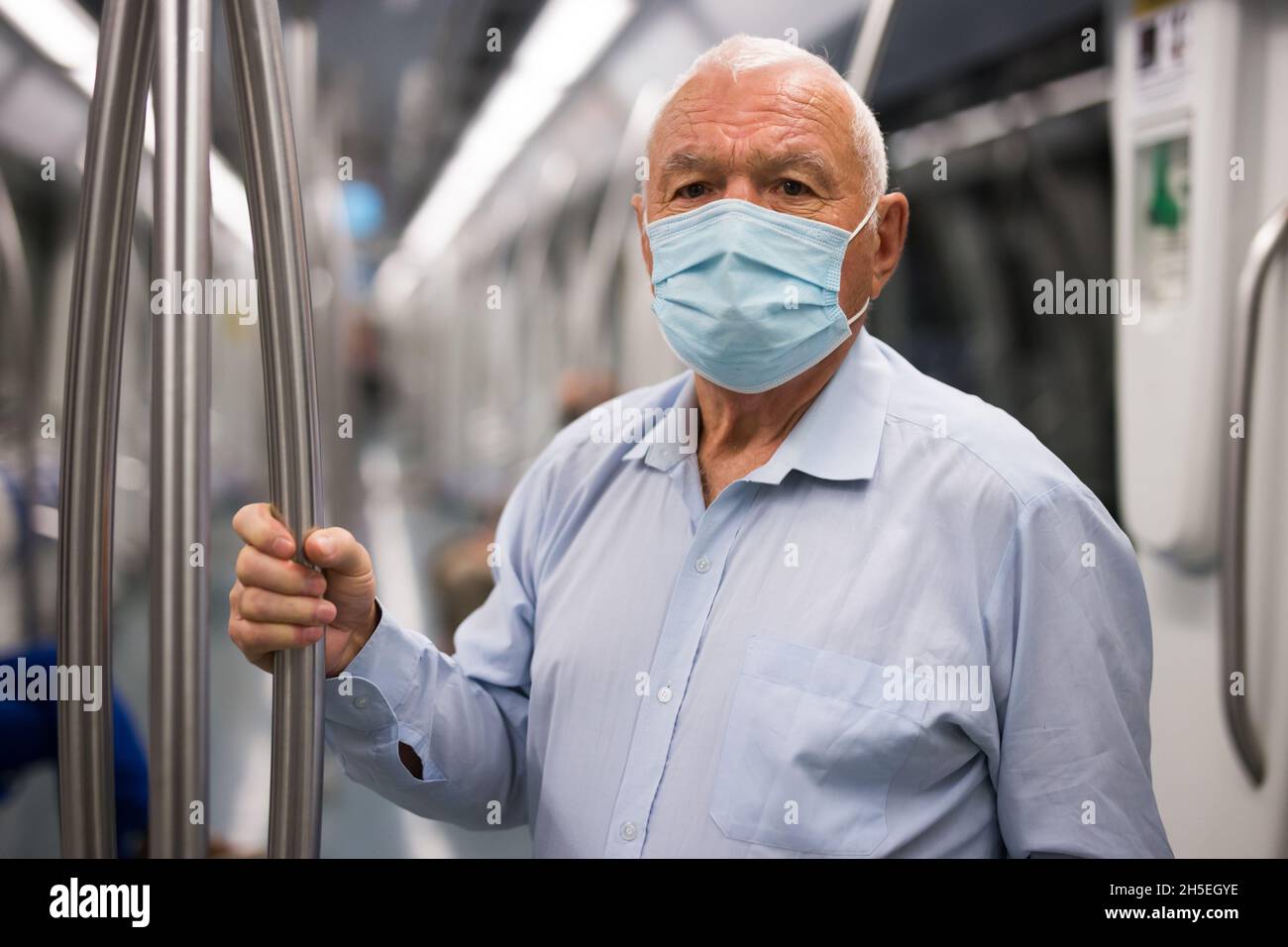 Elderly man in subway train Stock Photo - Alamy