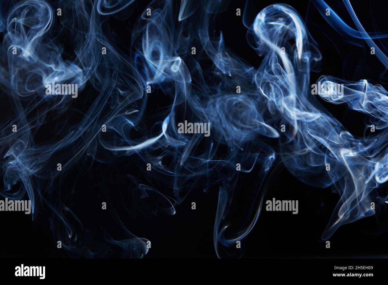 blue smoke on black background with abstract blur motion wave swirl ...