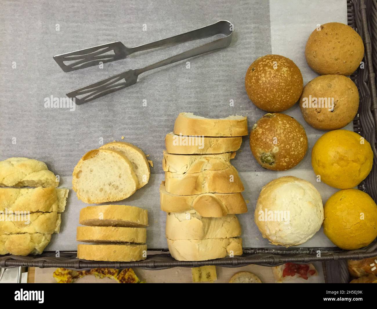 Top view of different types of bread and kitchen tongs Stock Photo - Alamy