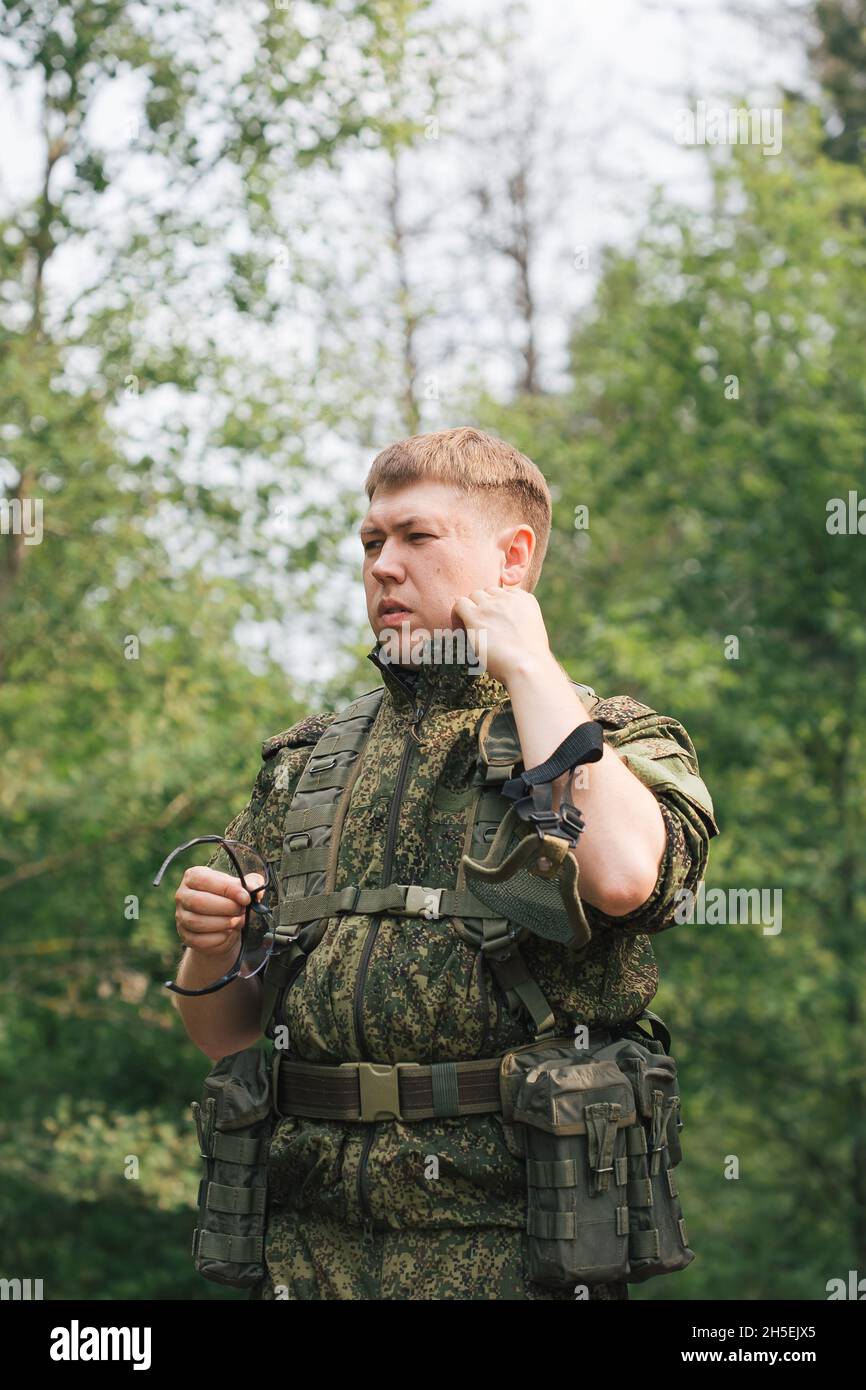 Fully equipped military men with automatic weapons getting ready to ...
