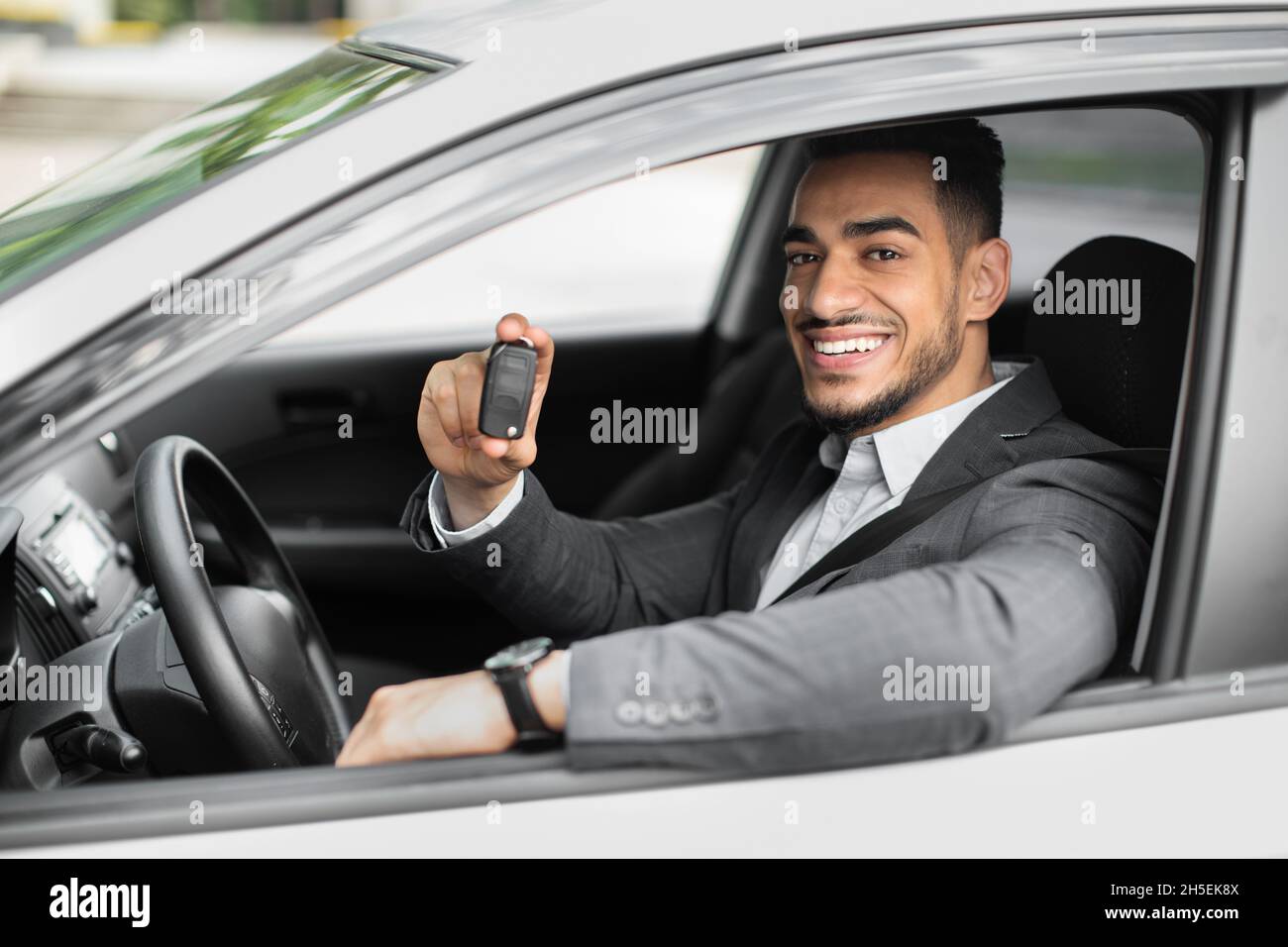 Handsome arabic businessman holding automatic car key Stock Photo - Alamy