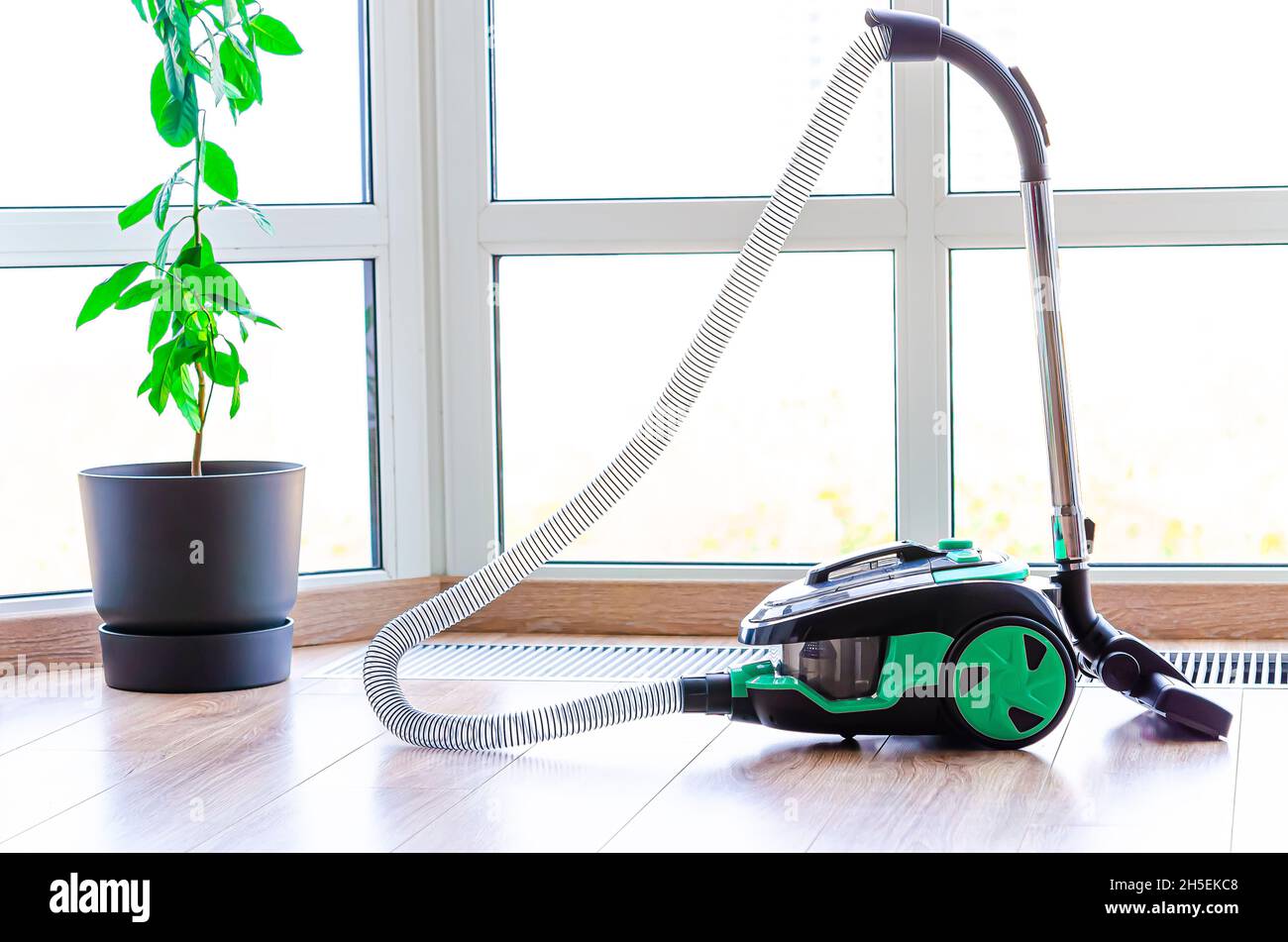 construction cleaning service. Light green vacuum cleaner on a window ...